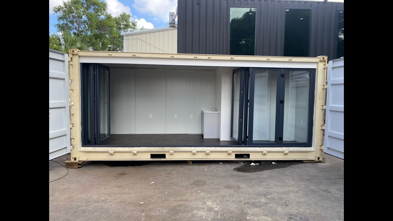 open side shipping container glass door installation - YouTube