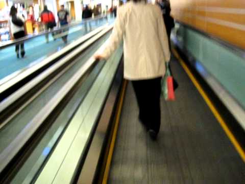 first time on walking escalator thingy - YouTube