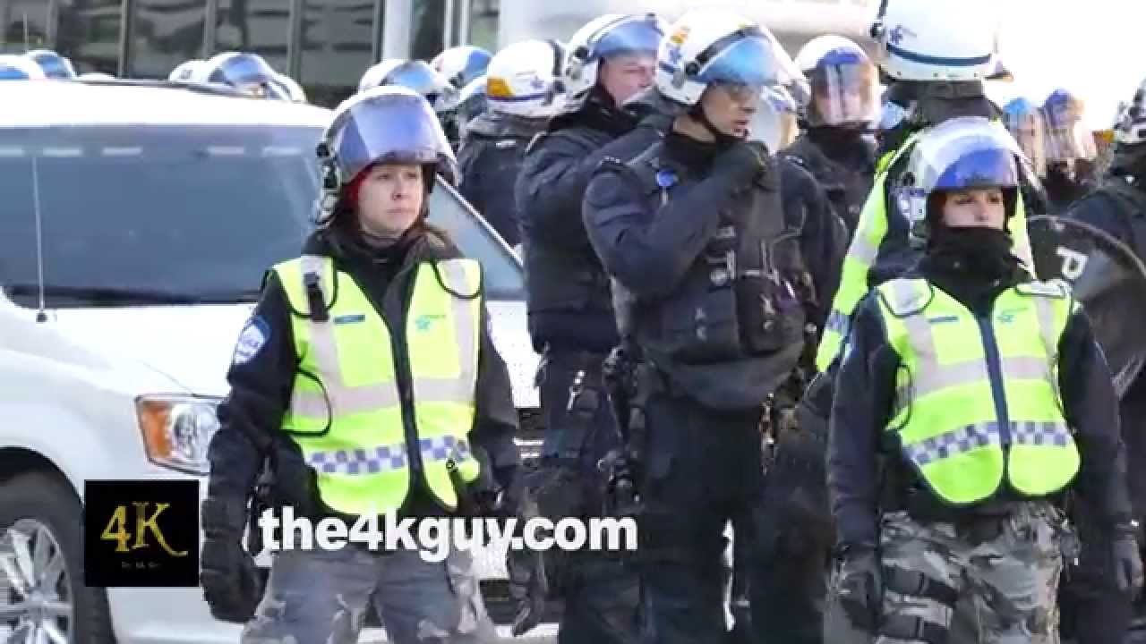 4K UHD - Two pretty female riot officers guarding in police line in the ...