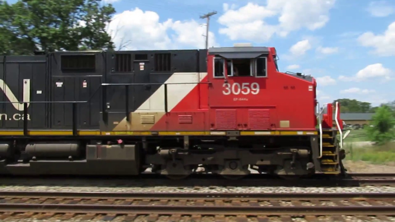 CN 3059, 8103 Eastbound train with BNSF, CARGILL covered hoppers and ...