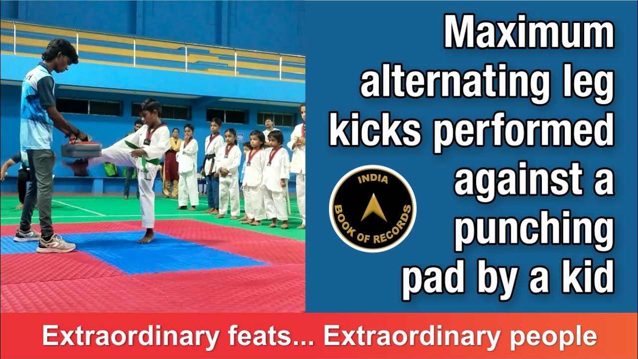 Maximum alternating leg kicks performed against a punching pad by a kid ...