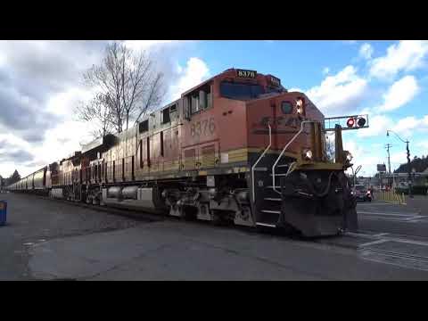 (Northbound) BNSF Loaded Grain Train slowly passes through the Main Street Railroad Crossing ...