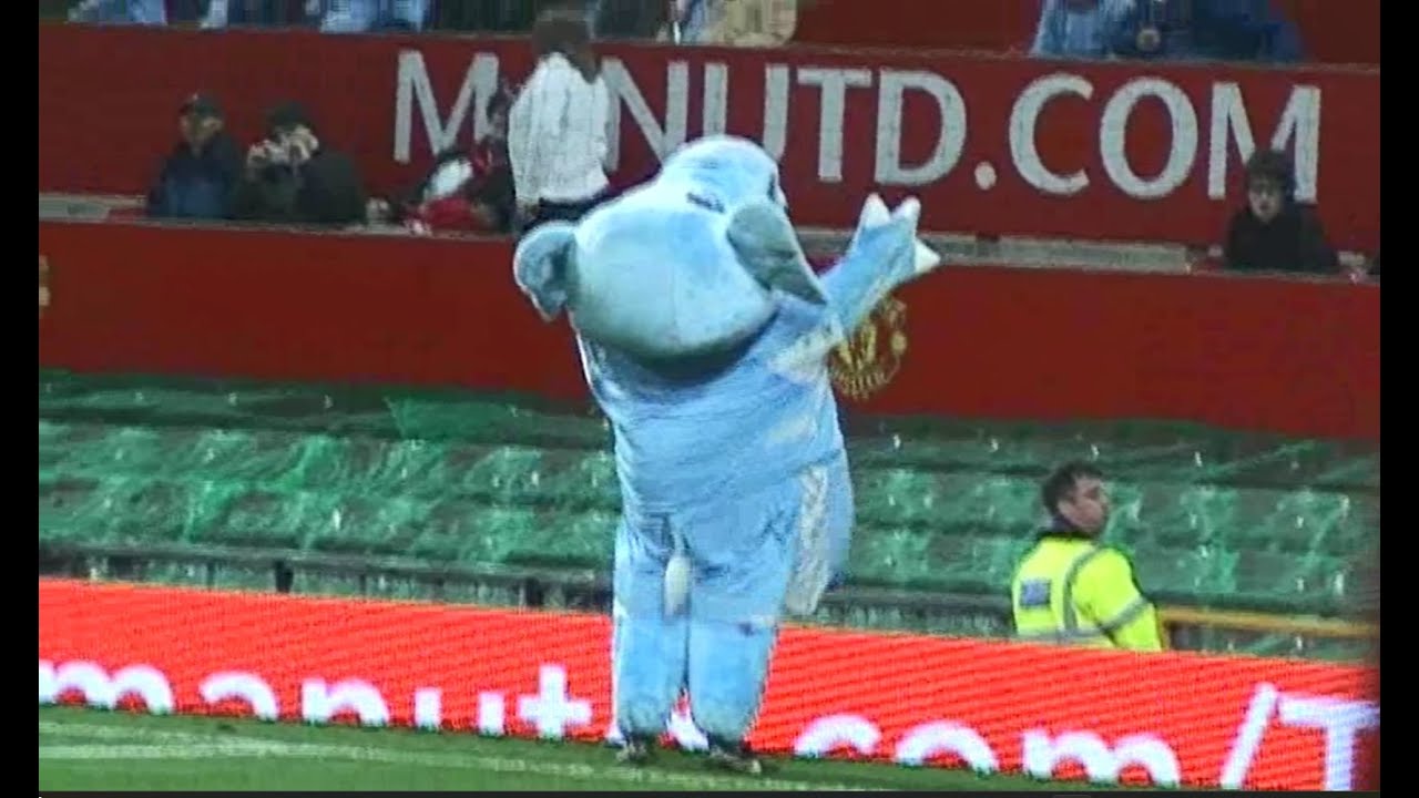 Fred the Red v Sky Blue Sam & Away Fans at Old Trafford Manchester ...