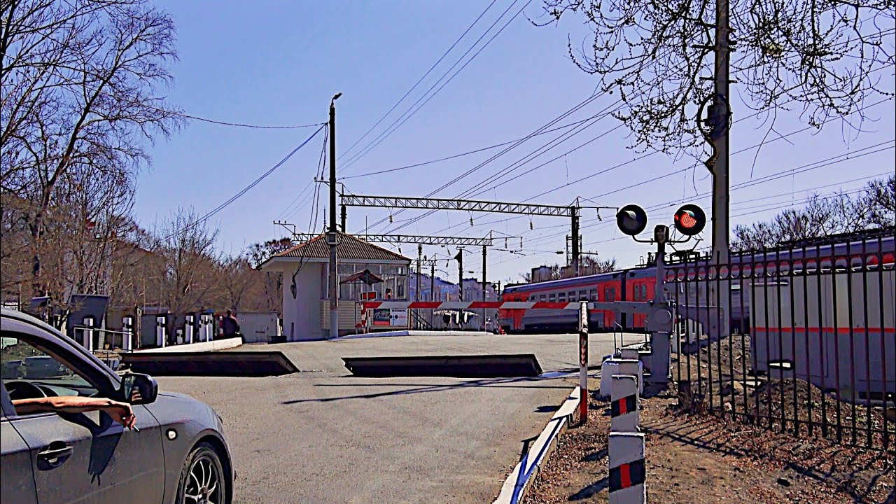 RailWay Russian Railroad Crossing. The EMU Train crosses the road ...