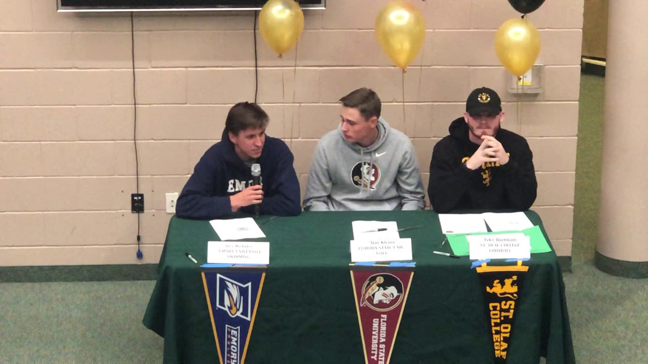 Seniors sign college commitment letters during assembly - YouTube