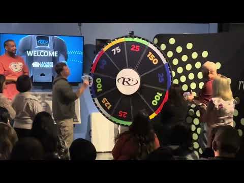Susie spinning the money wheel at Rainbow open house 2.12.24 I don’t ...