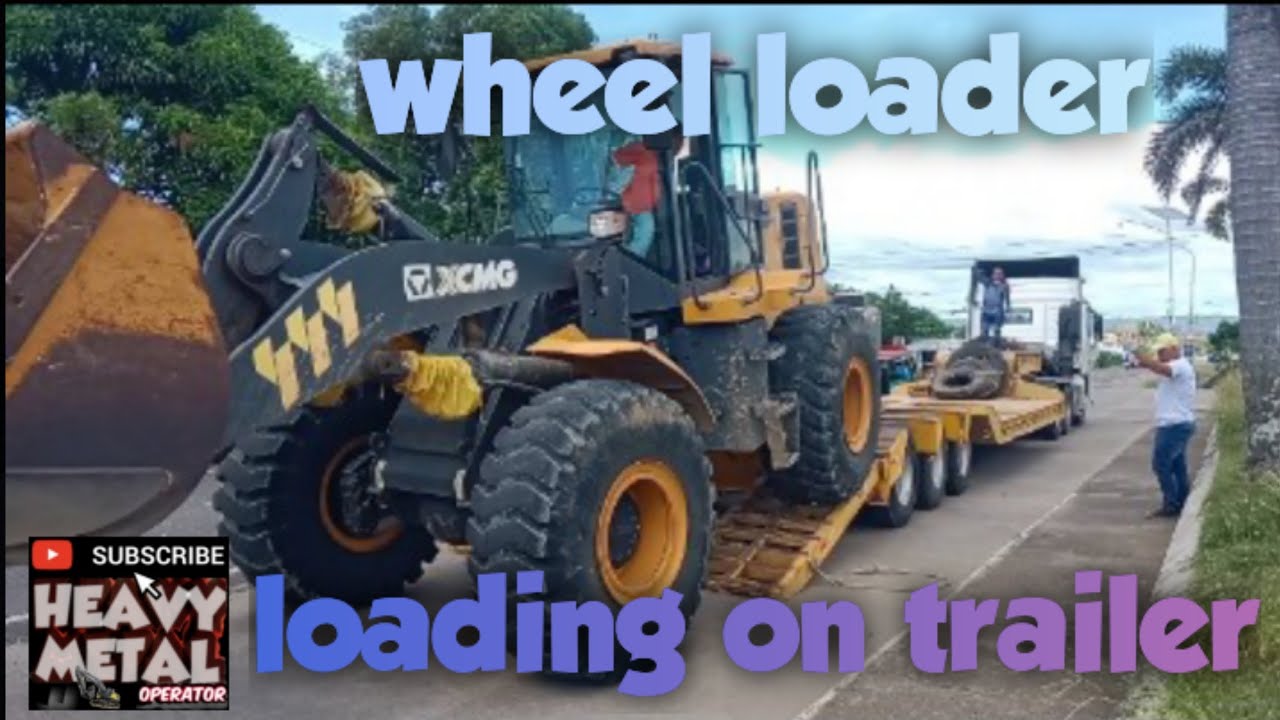 wheel loader loading on trailer - YouTube