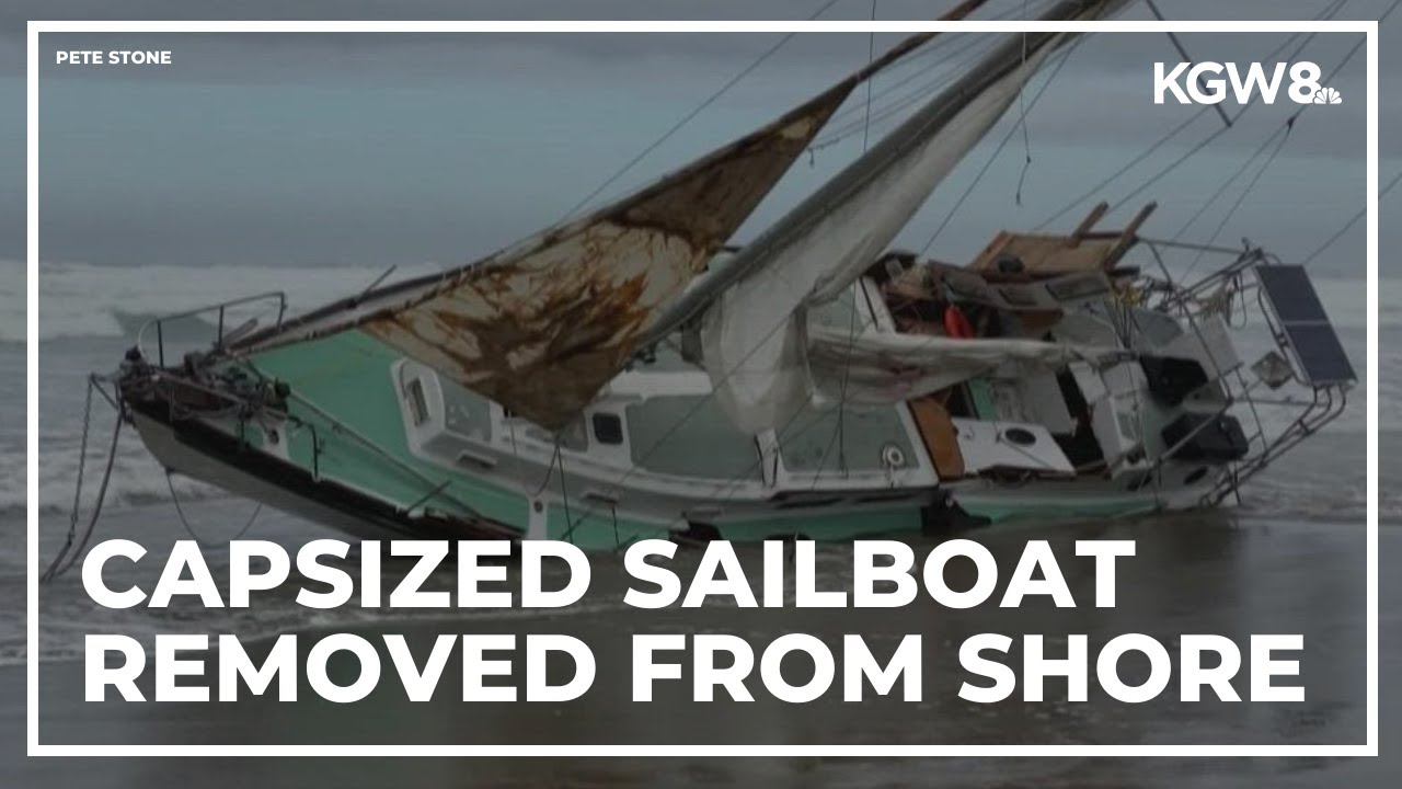 Capsized sailboat removed from shore near Rockaway Beach - YouTube