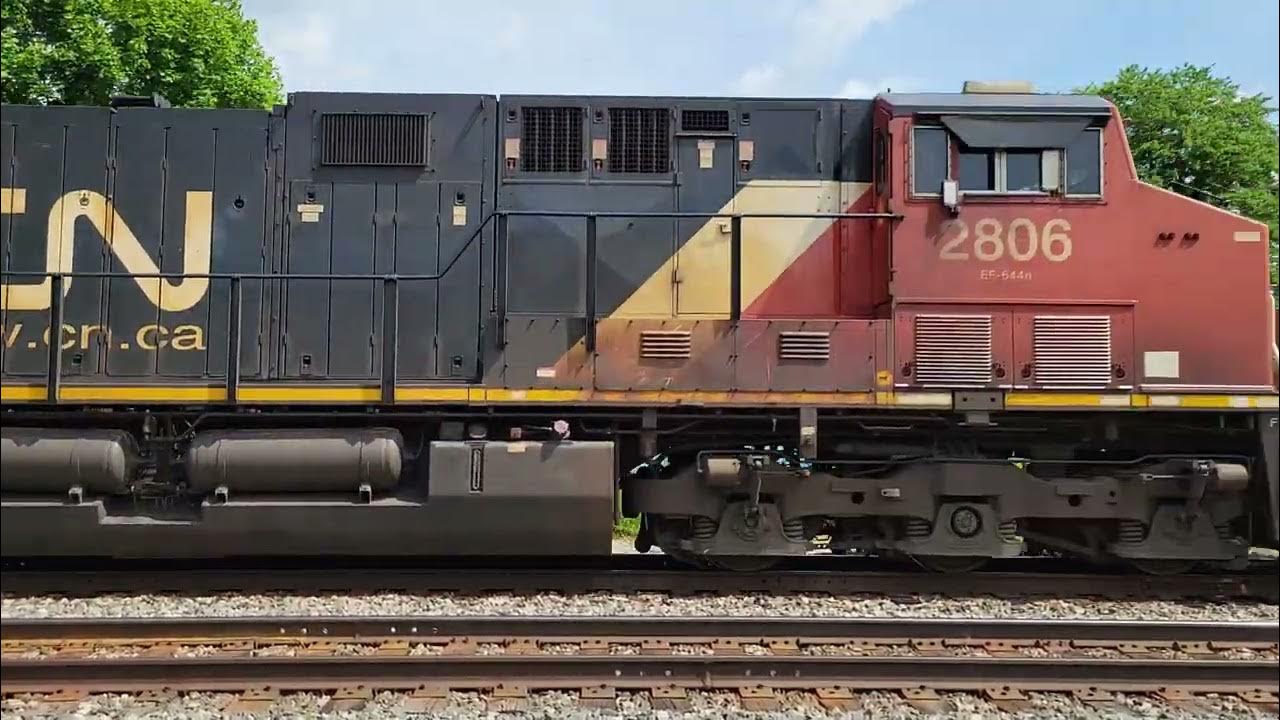 Eastbound freight train with GATX, LMIC flatcars, BN, BNSF hoppers, CN 2806 at Vicksburg, MI ...