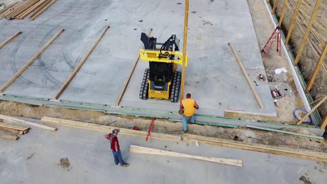 Post Grabber with 28' tall laminated columns and skid steer. - YouTube