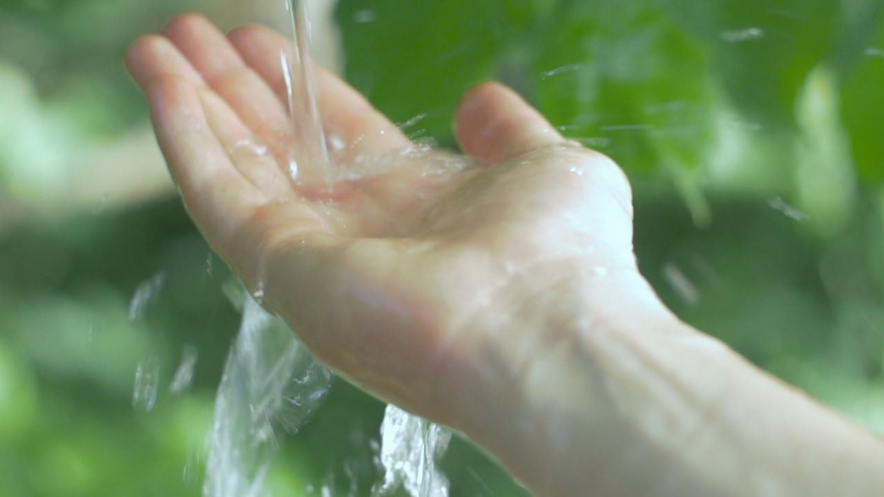 videoblocks slow motion of clear water streaming on a human hand taking ...