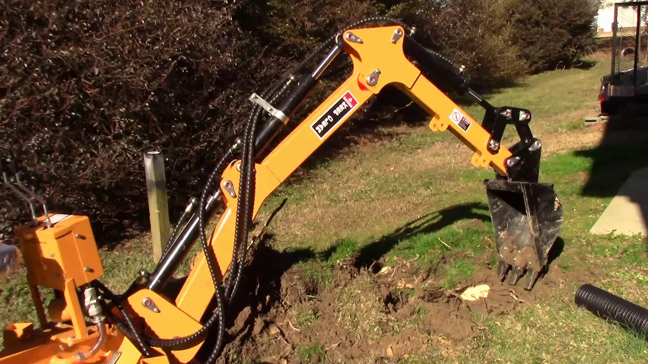 ATBH7 towable backhoe digging up root balls from shrubs. - YouTube