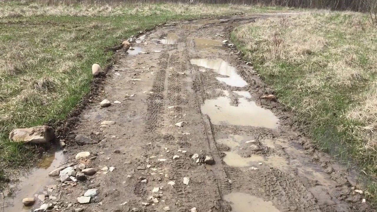 Using a compact tractor and box blade to grade and remove puddles - YouTube