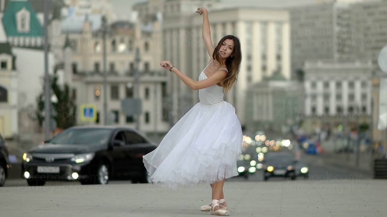 Ballet dancer dances against the background of passing cars - Stock ...