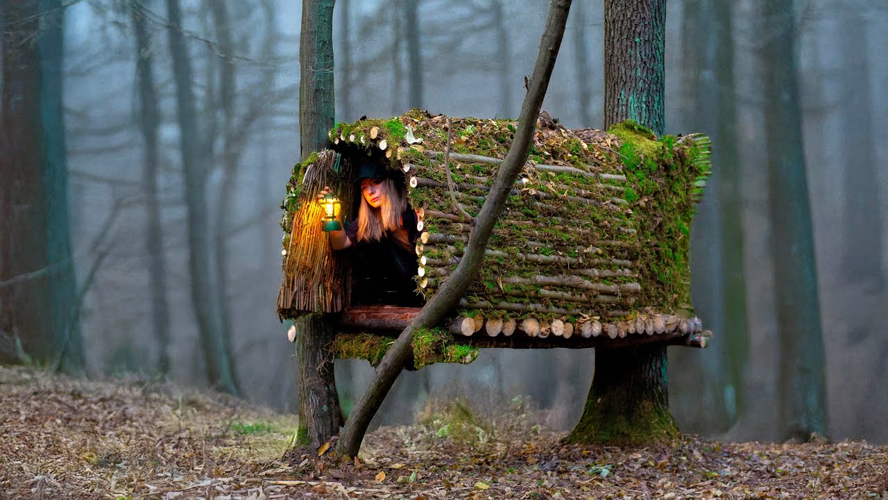 Building a Cozy Log Survival Shelter Above Ground Between Two Trees ...