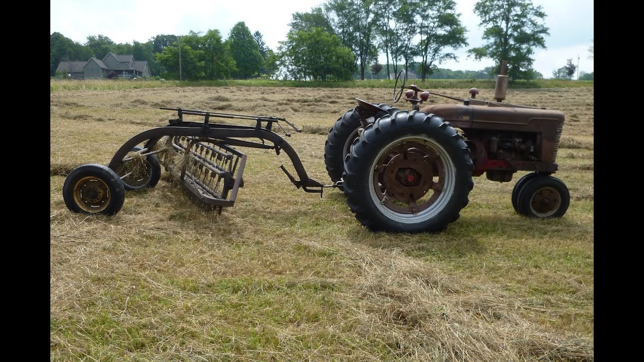 New Holland Rolabar Rake in Operation - YouTube