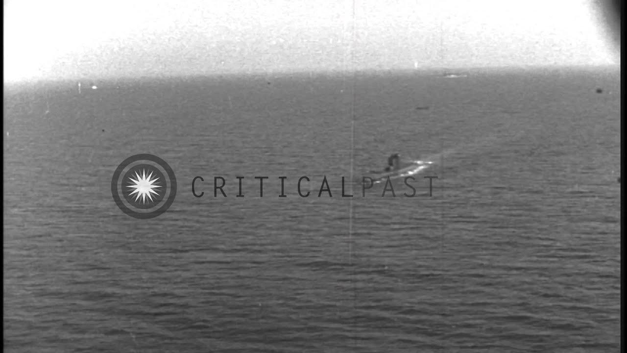 Aerial view of a US submarine underway and submerging in the Pacific ...