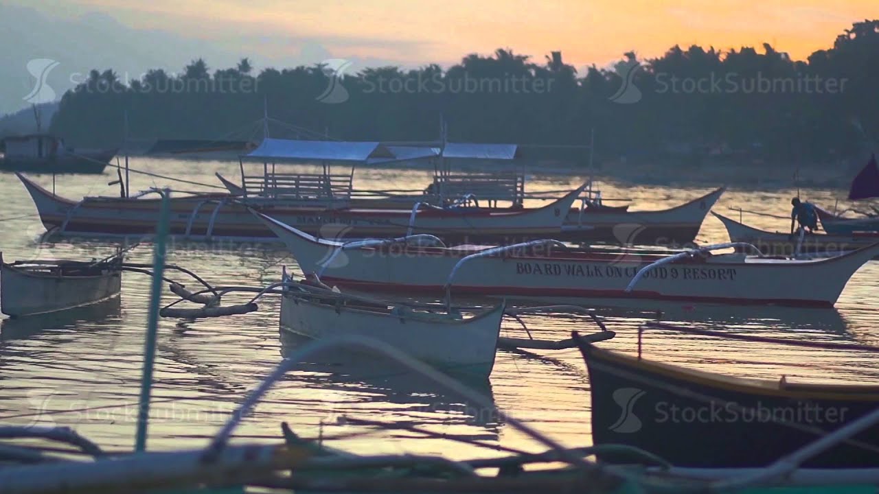 Boats bobbing on the waves in the dusk of the setting sun - YouTube