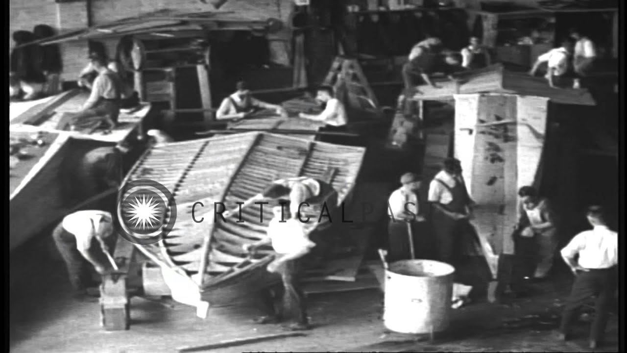 Men working on parts of a ship in a ship building factory in the United ...
