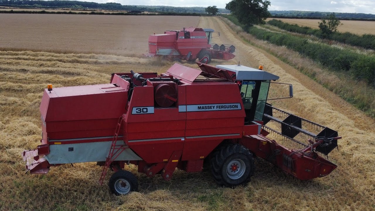 Barley harvest has started. Takeaway driver drives the combine ...
