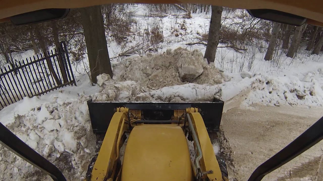 clearing snow with the huge loader bucket and stirring leaves - YouTube
