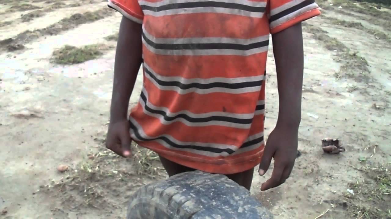 a street boy playing on the mud field - YouTube