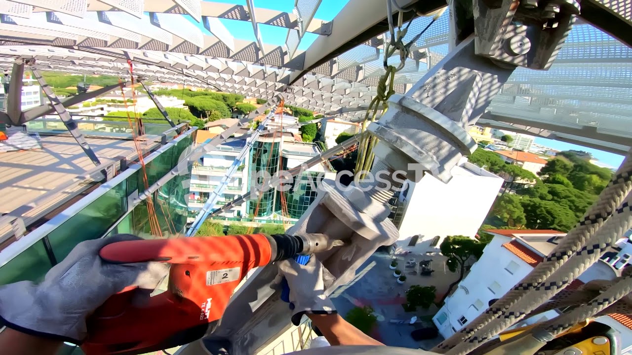 Abseiler does maintenance on exterior building facade - YouTube