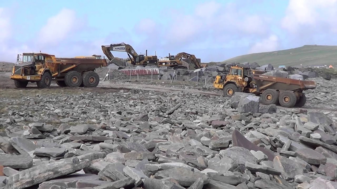 ASHLEIGH CONTRACTS Offloading a barge full of large rock armour - YouTube