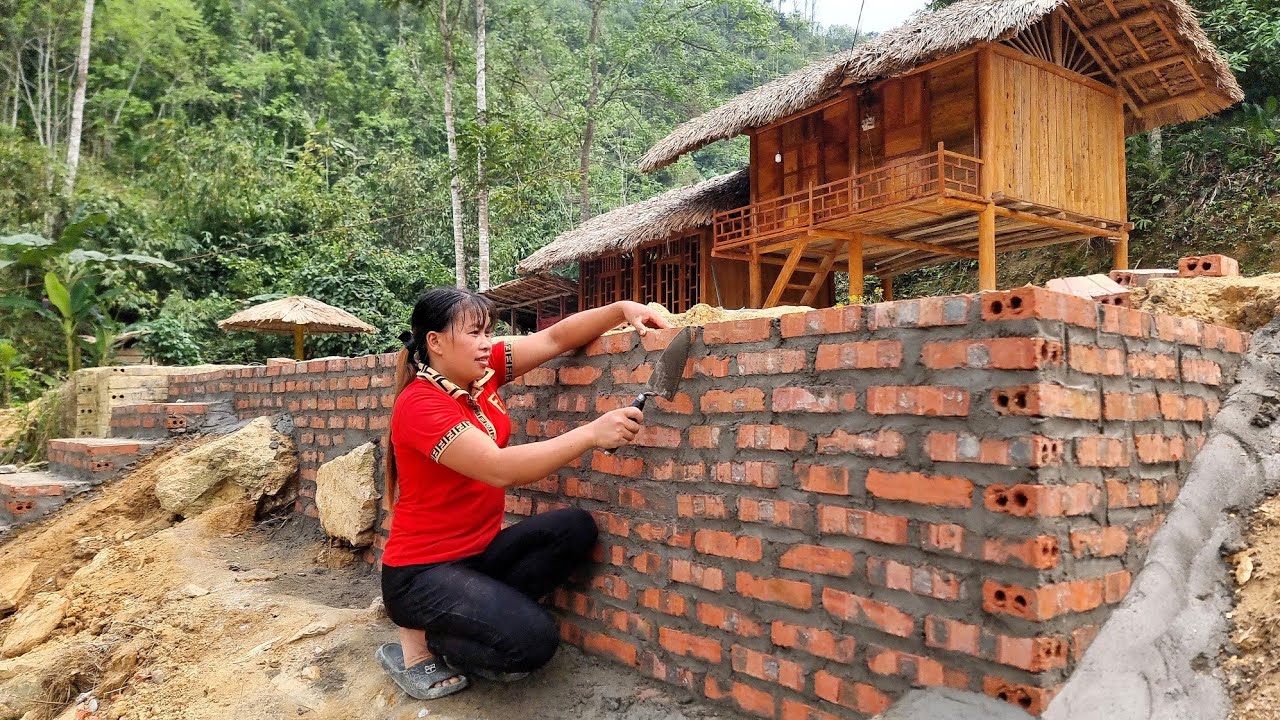 Single girl, wall construction technique using red bricks, cement and ...