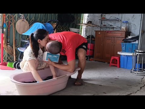 Comedy husband and wife prank kiss when doing laundry