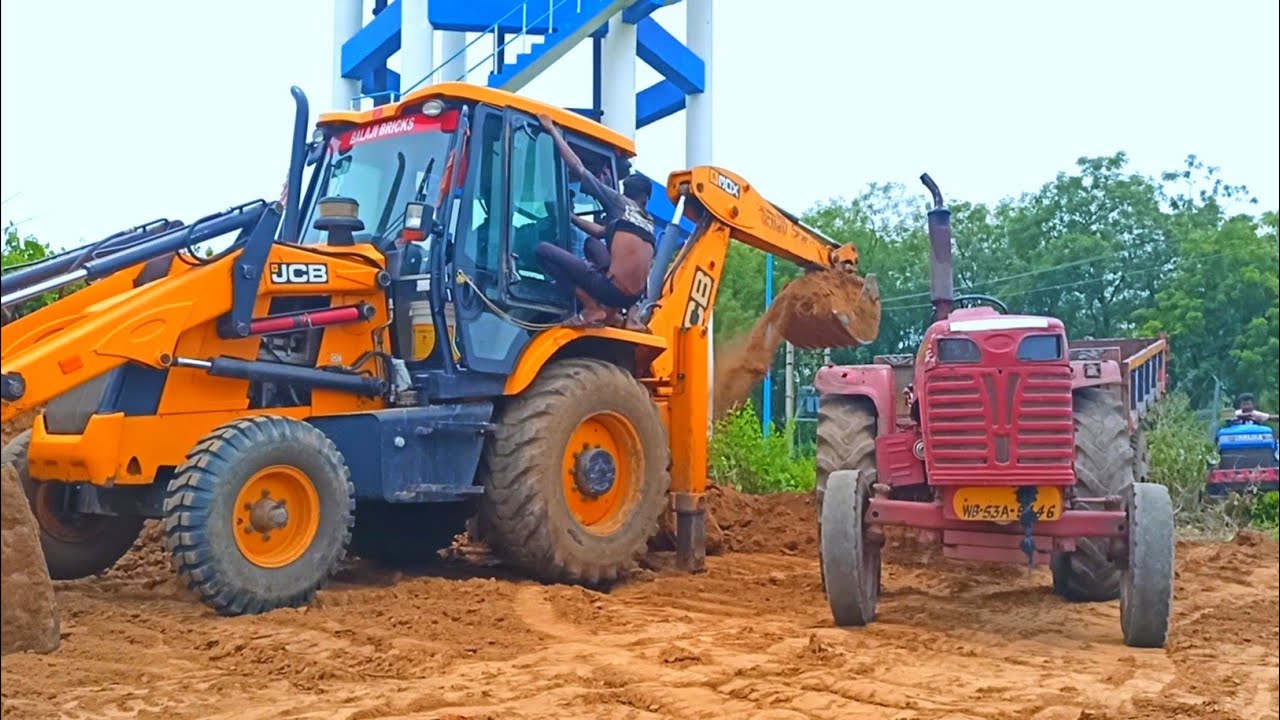 Jcb 3dx Backhoe Loader Machine Loading Red Mud In Mahindra 295 DI ...