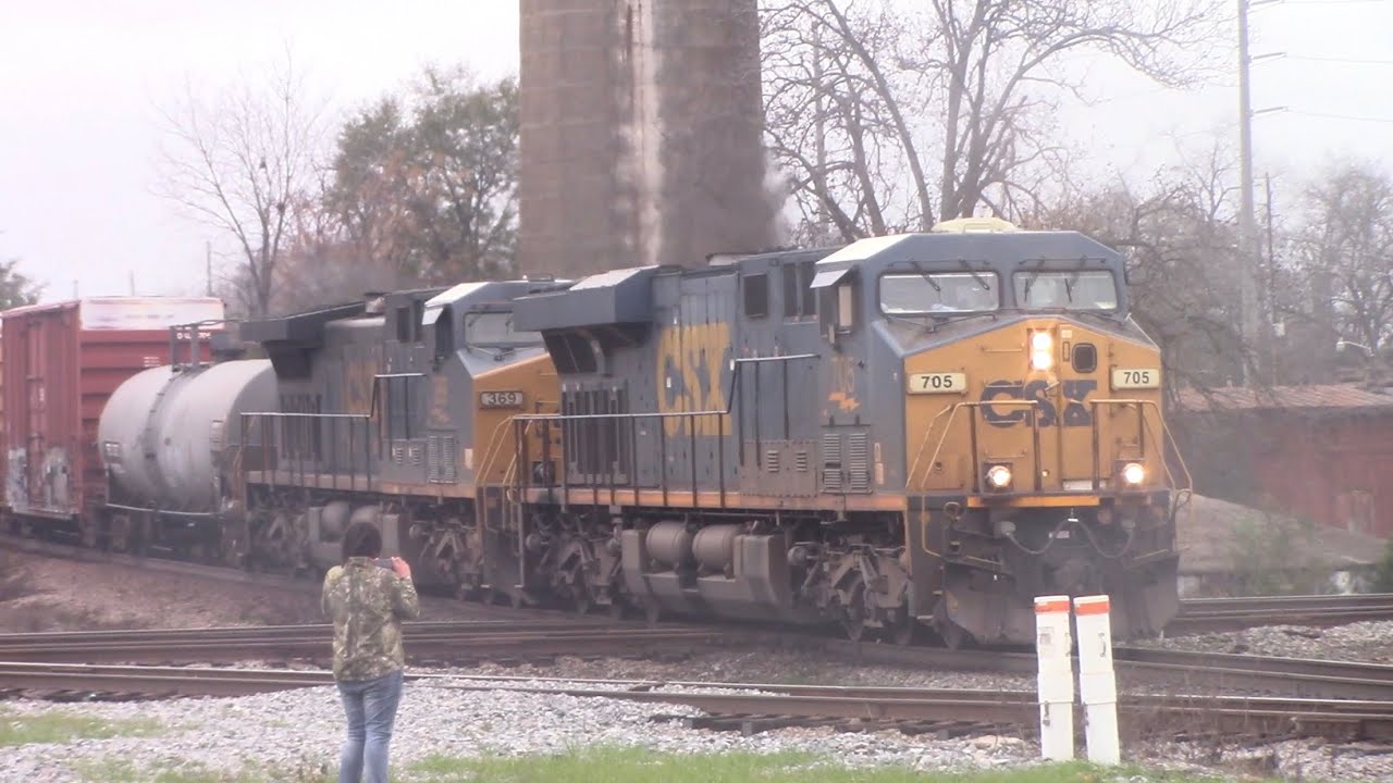 CSX 705 with a nice engineer playing with the horn leads M515-19 in ...