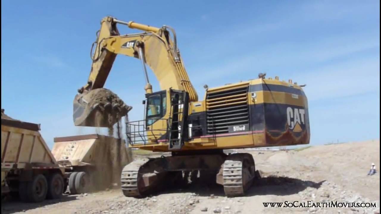 CAT 5110B loading trucks - YouTube