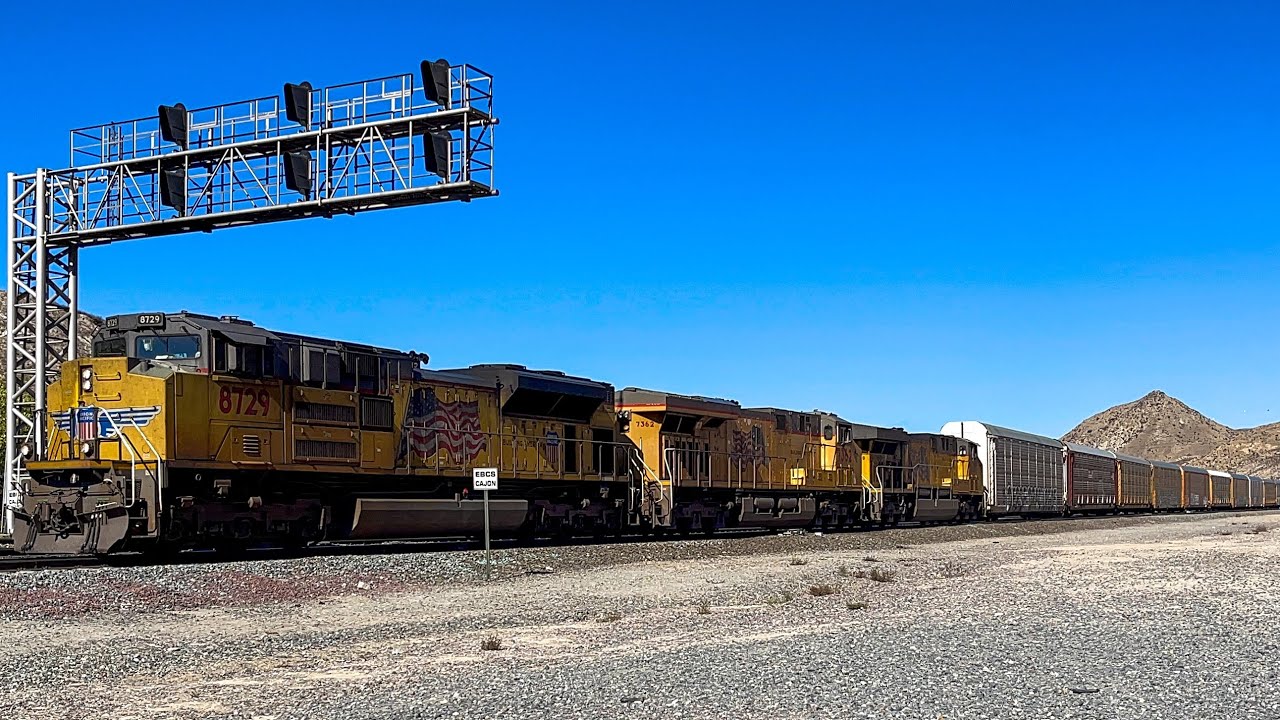 Union Pacific Autorack train west bound swings around tied down BNSF Intermodal. Cajon Pass ...