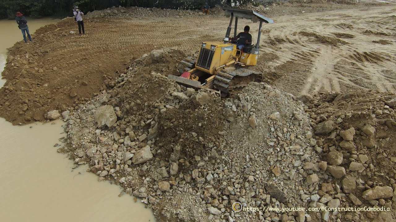 Bulldozer Pushing Soil Filling Up Pit In Water - HINO NISSAN 5 Ton Dump ...