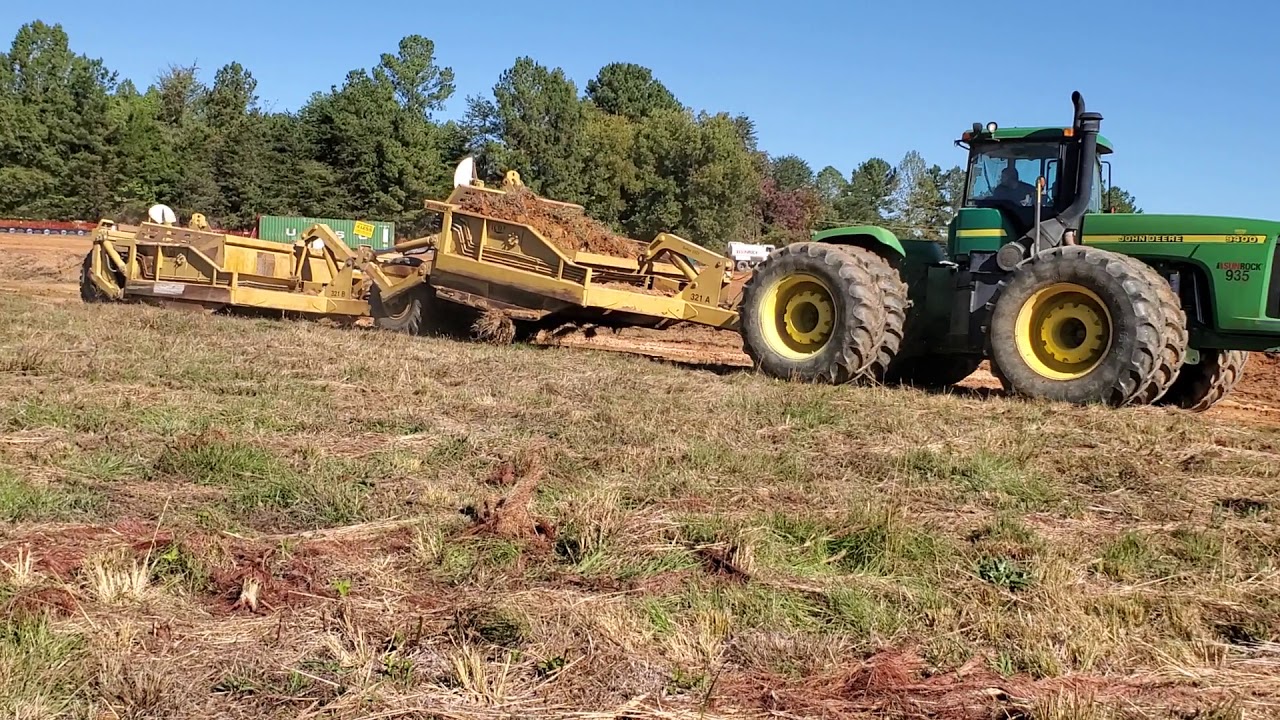 Strip and load topsoil with a tractor pan - YouTube