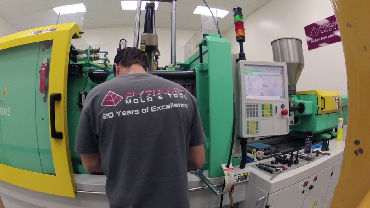 Loading a hot plastic injection mold - YouTube