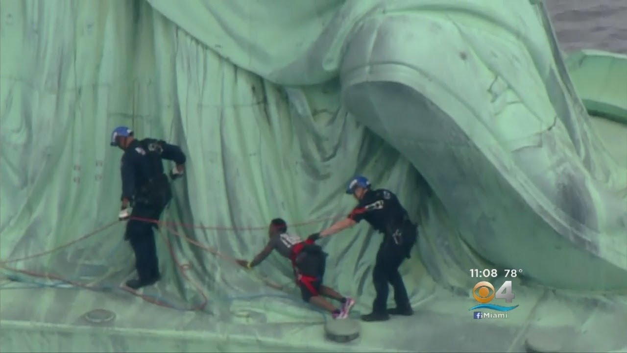 Woman Climbs On The Bottom Of The Statue Of Liberty, 7 Arrested - YouTube