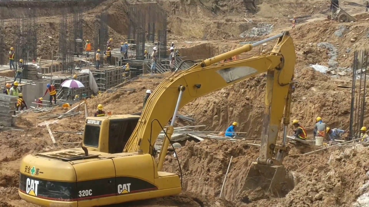 Excavators are Digging the Mud in Construction Site - YouTube
