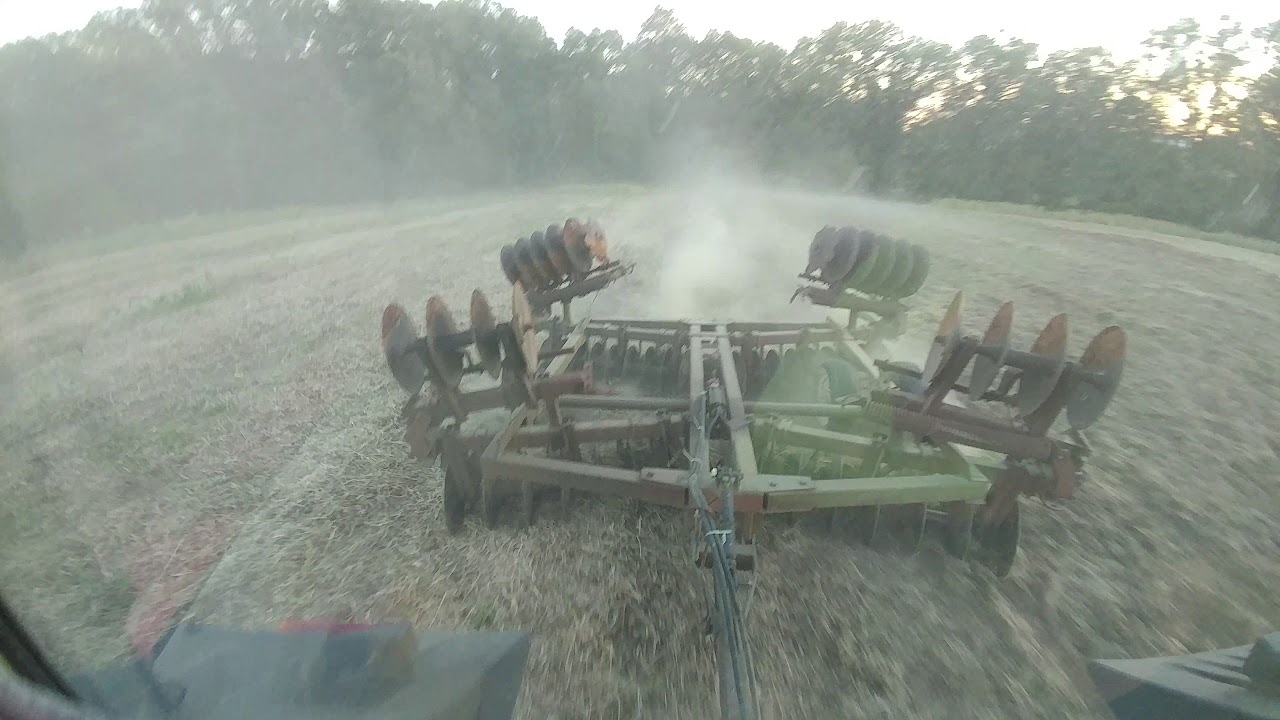 Disking under soybean stubble - YouTube