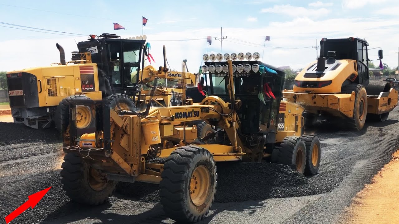 motor grader operator grading and cutting gravel foundation new road ...