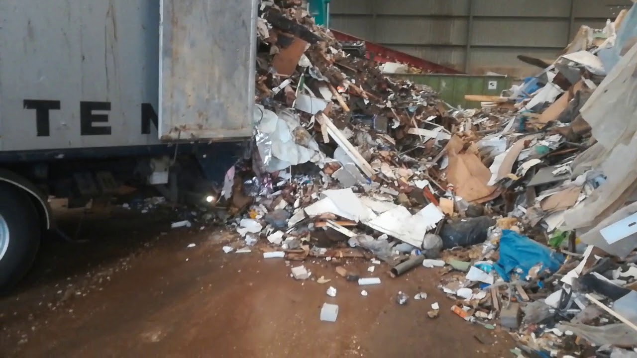 Unloading a walking floor trailer full of construction waste - YouTube