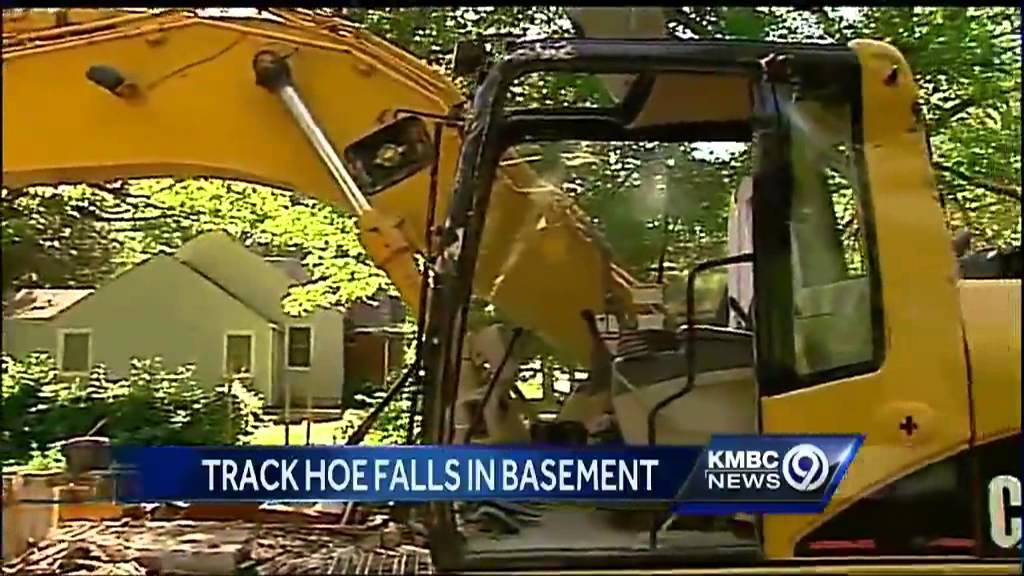 Worker OK after demolition equipment falls into hole - YouTube