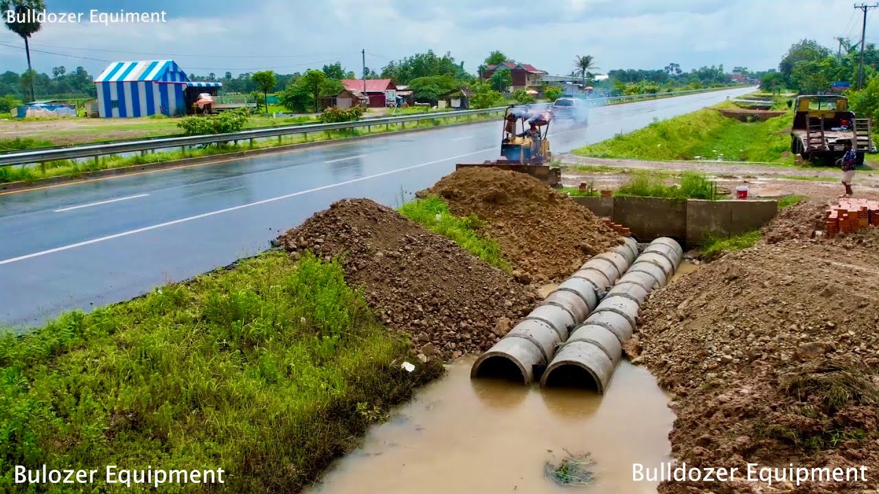 Machinery clearing and clearing land next to ASEAN Roads in the rain by ...