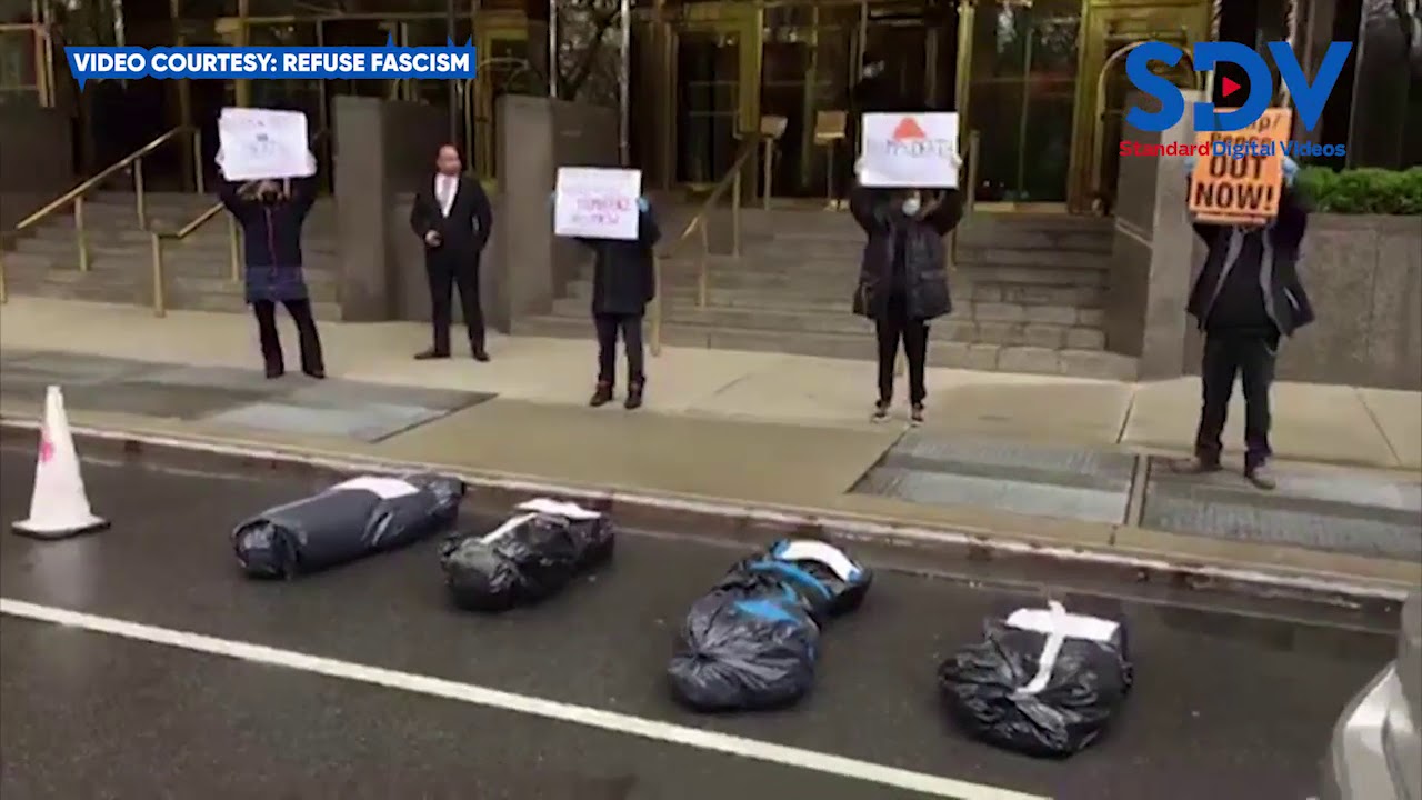 Protesters lie body bags outside Trump buildings to protest the US ...
