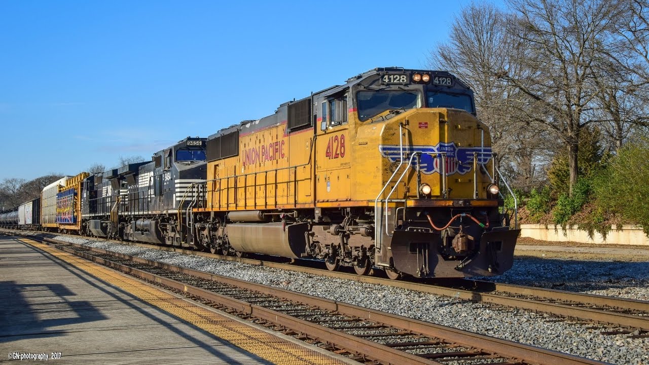 NS: Union Pacific leads a freight train by the AMTRAK Station ...