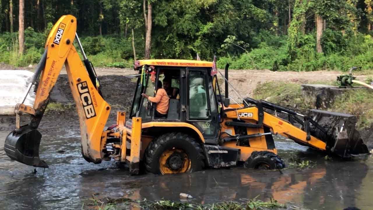 A JCB Machine Entering The Middle Of The Bay And Cleaning The Pool ...
