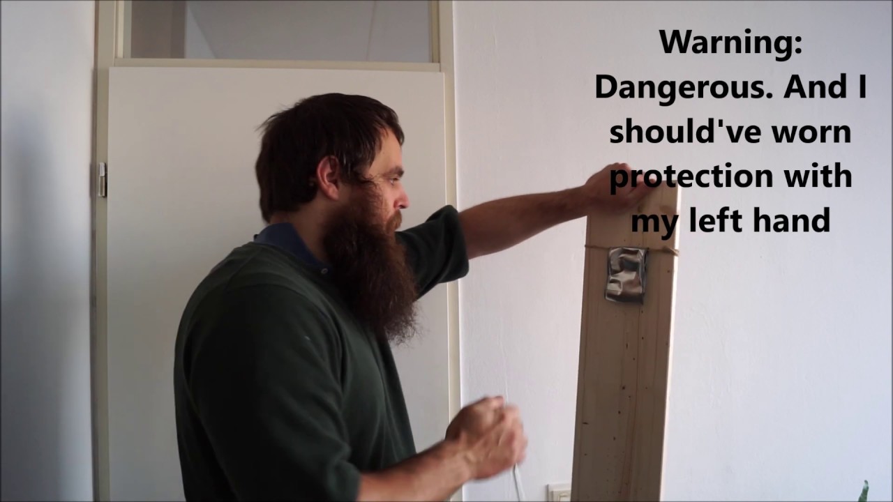 Human nail gun training with a big nail against a quit thick aluminum ...