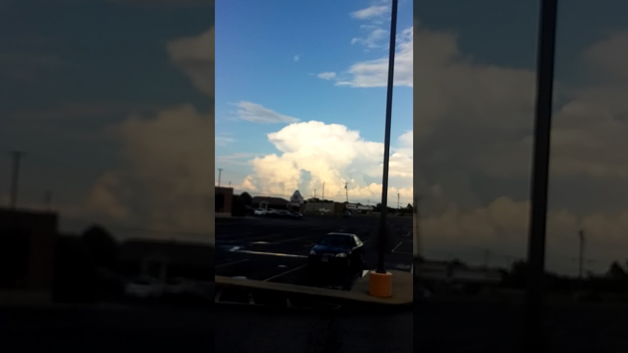 Cumulonimbus clouds anvil structure with partial rainbow to north - YouTube