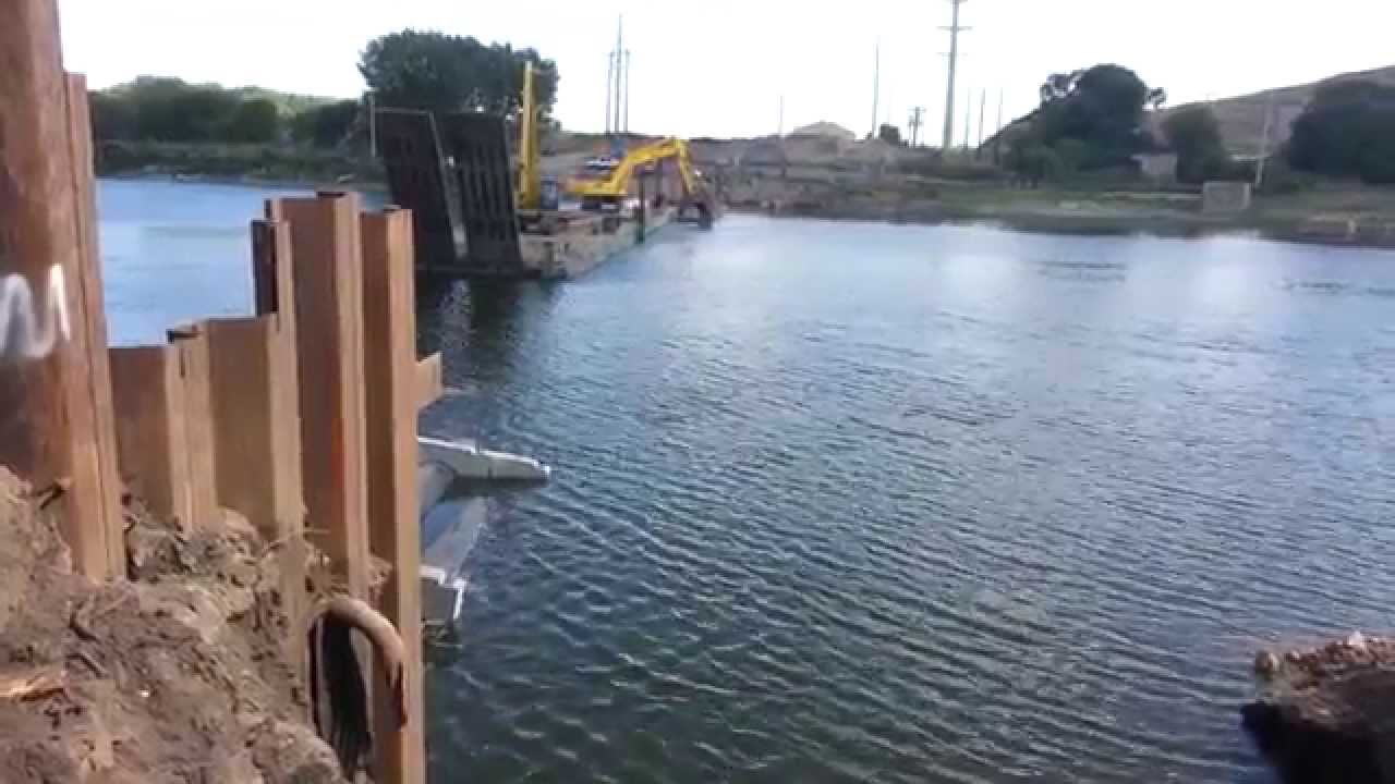 Sinking of pipe across cedar river - YouTube